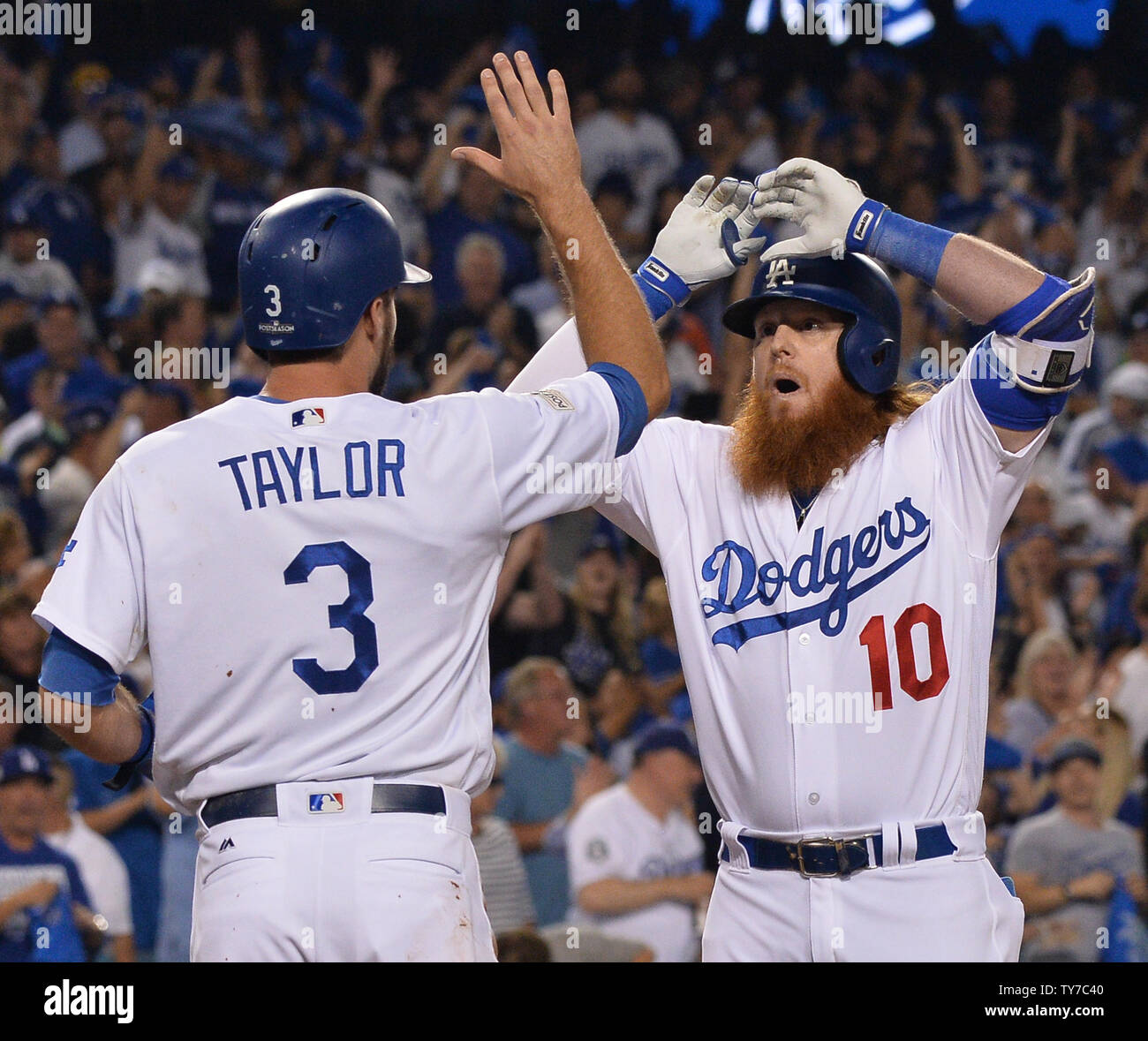 Los Angeles Dodgers Justin Turner (10) high fives Corey Seager after scoring on a three-run home ...
