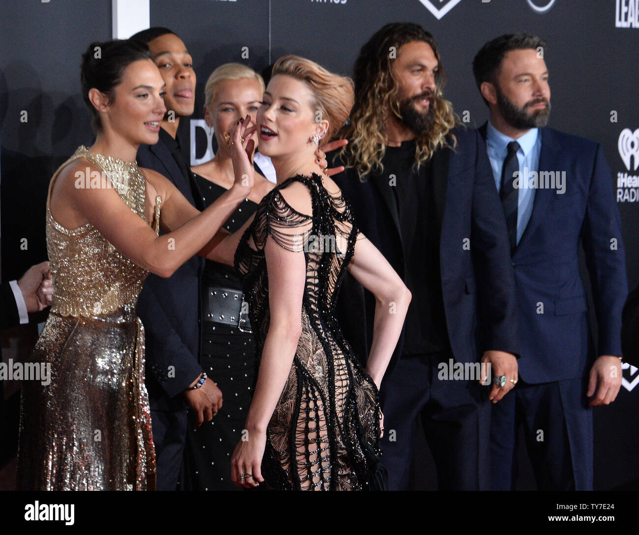 Actresses Gal Gadot (L) and Amber Heard interact as cast members gather ...