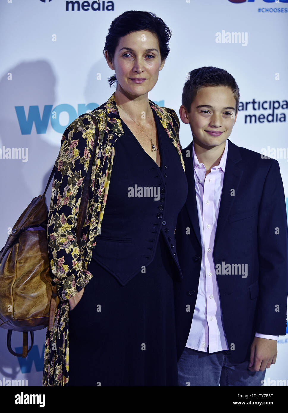Carrie-Anne Moss and her son Jaden Roy arrive for the premiere of ...