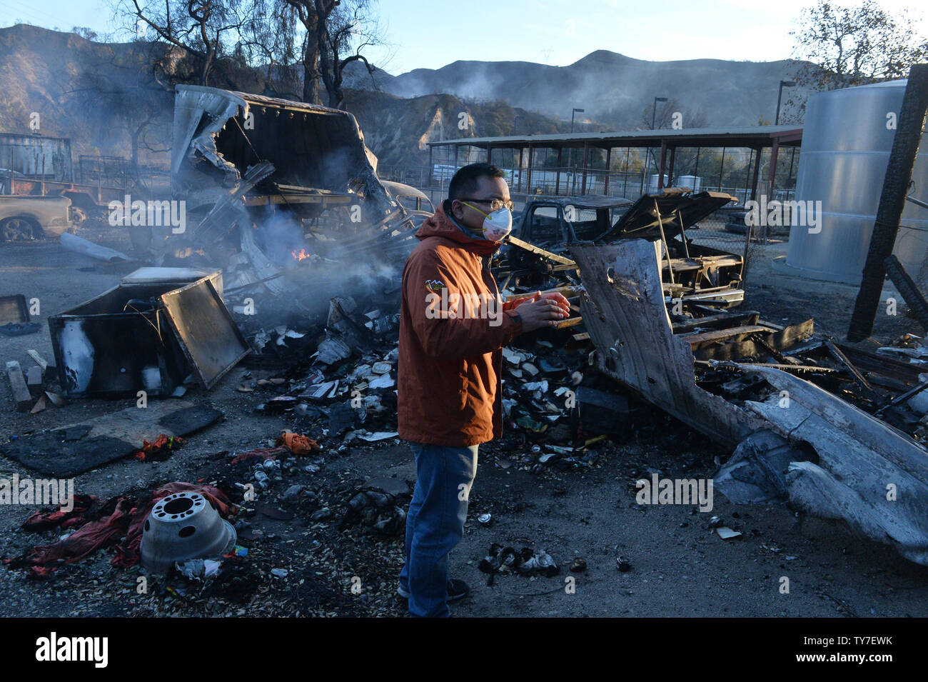 A reporter form Chinese Central Television does a standup among fire ...