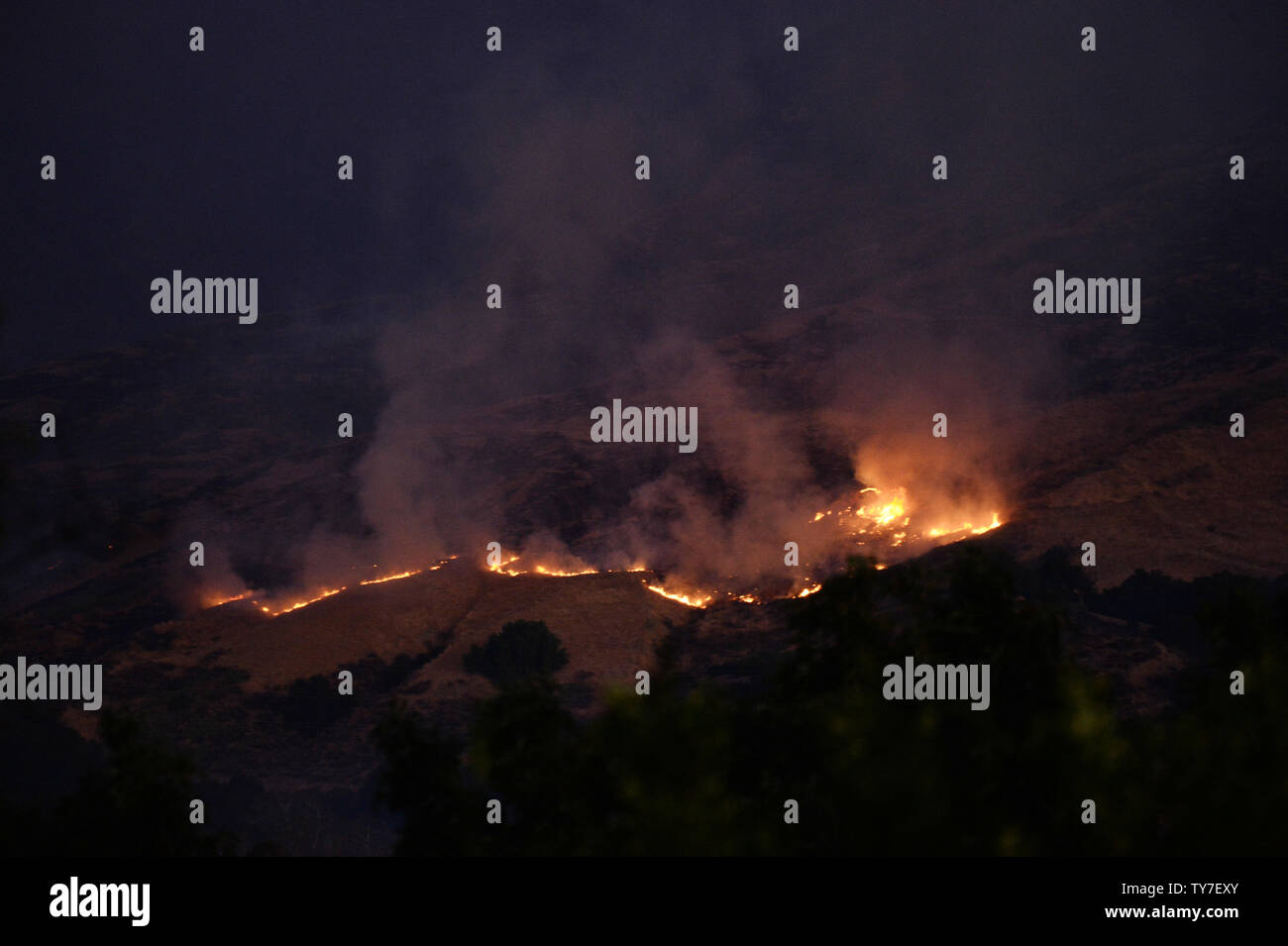 Flames from the Thompson fire can be seen in the early morning hours ...