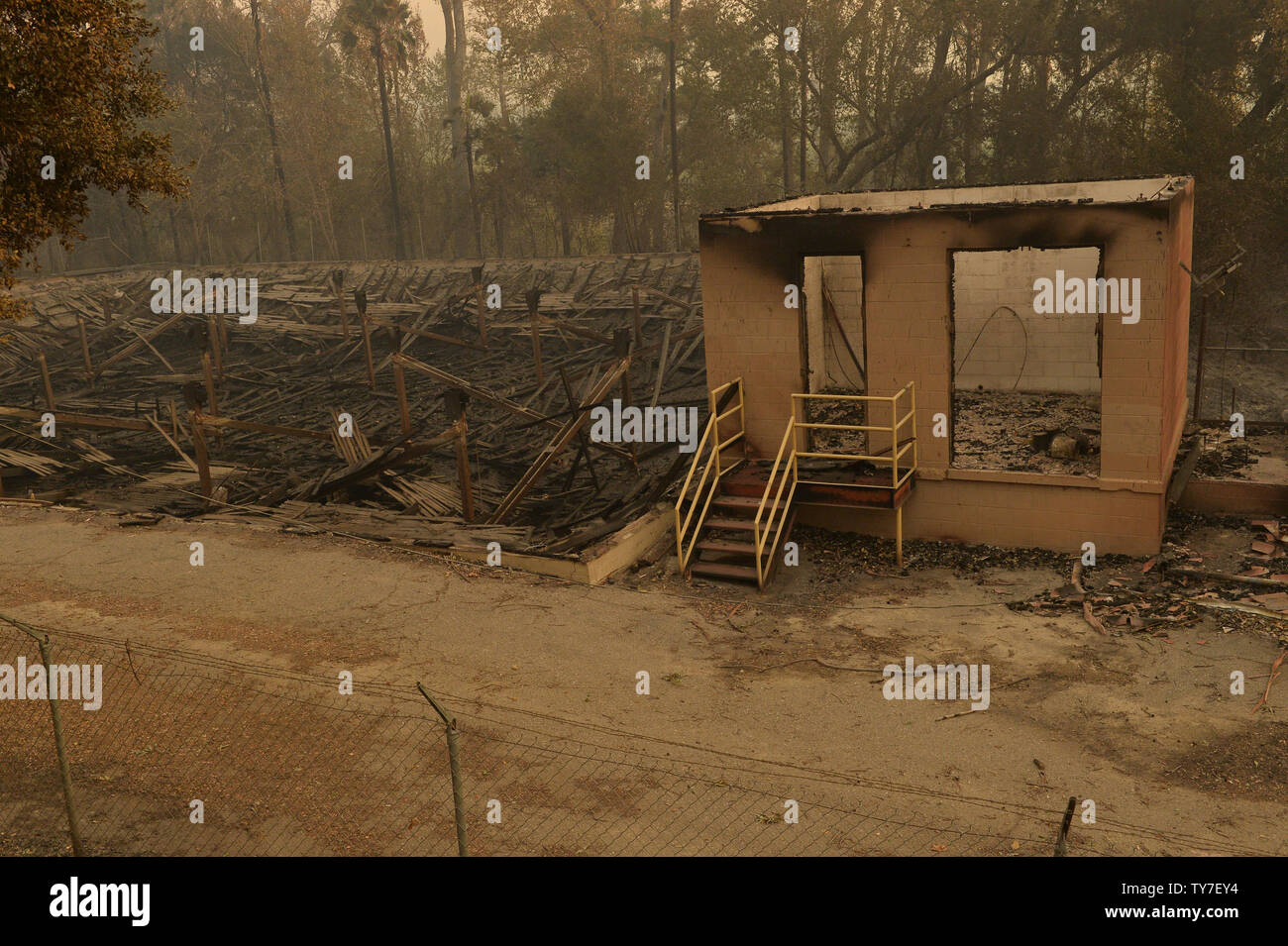 A shack is among that remains of the large structure, rear, destroyed ...