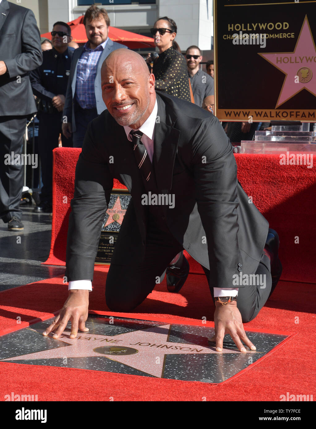 Actor Dwayne Johnson, aka "The Rock" touches his star during an ...