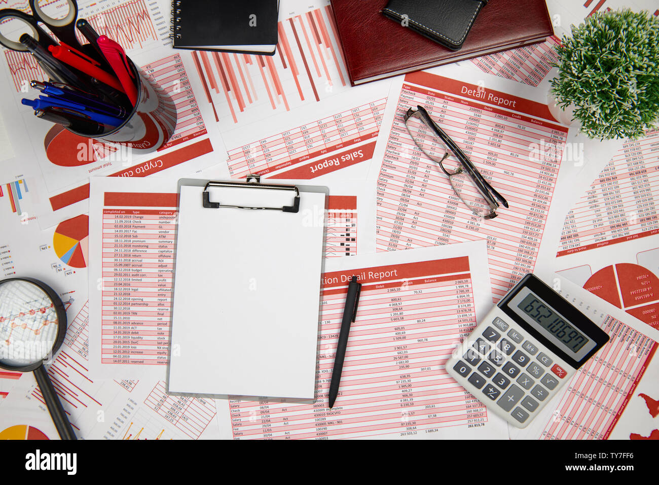 Business reports, blank paper sheet, data tables and charts - directly ...