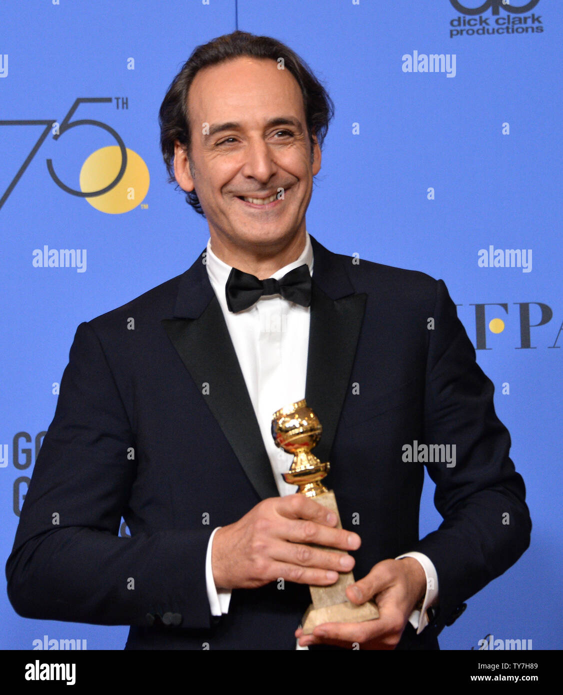 Composer Alexandre Desplat appears backstage after winning the award ...