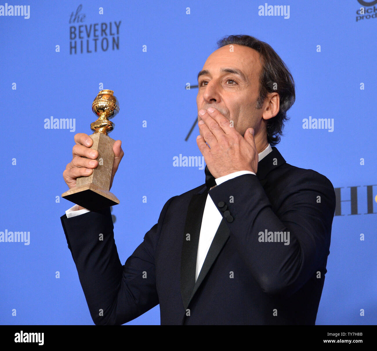 Composer Alexandre Desplat appears backstage after winning the award ...
