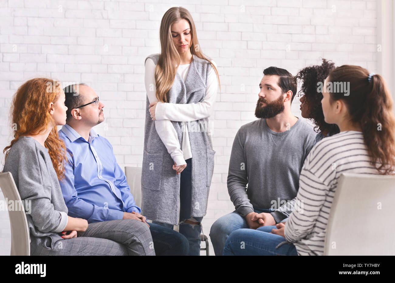 Problematic woman talking with support group about her problems Stock ...