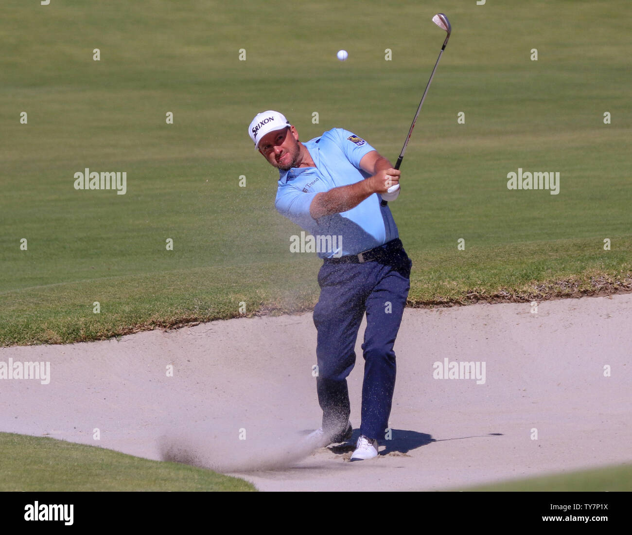 Graeme McDowell hits out of a bunker during the final round of the ...