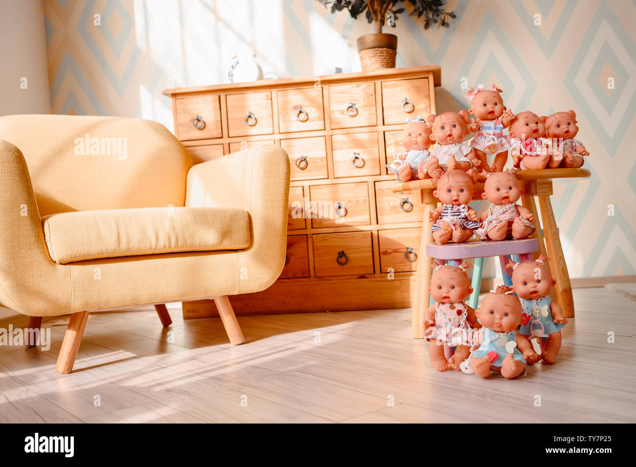 Group of cute baby dolls on the table on bright background Stock Photo ...