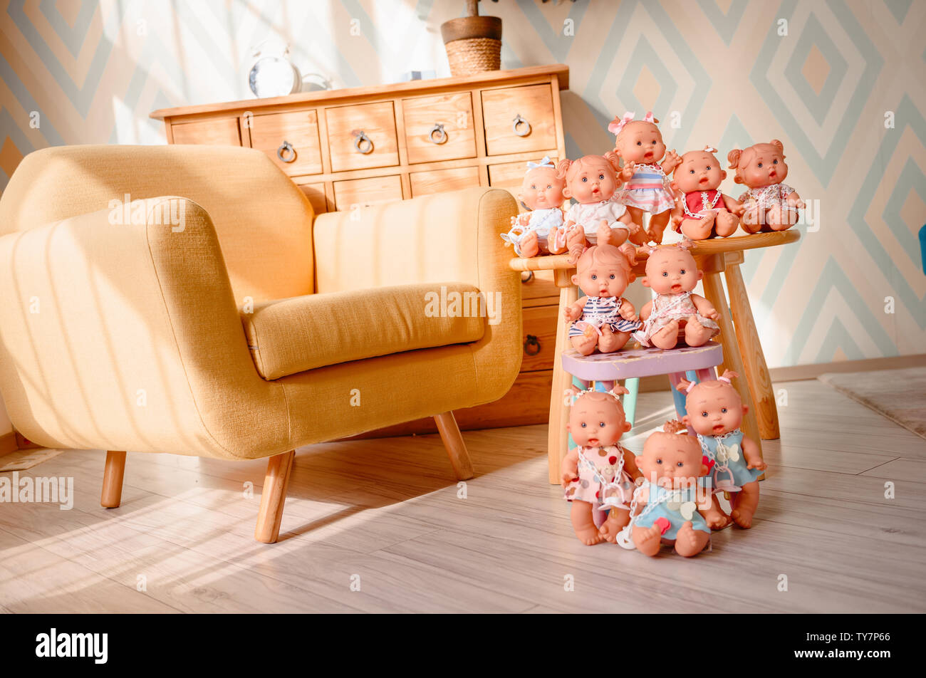 Group of cute baby dolls on the table on bright background Stock Photo ...