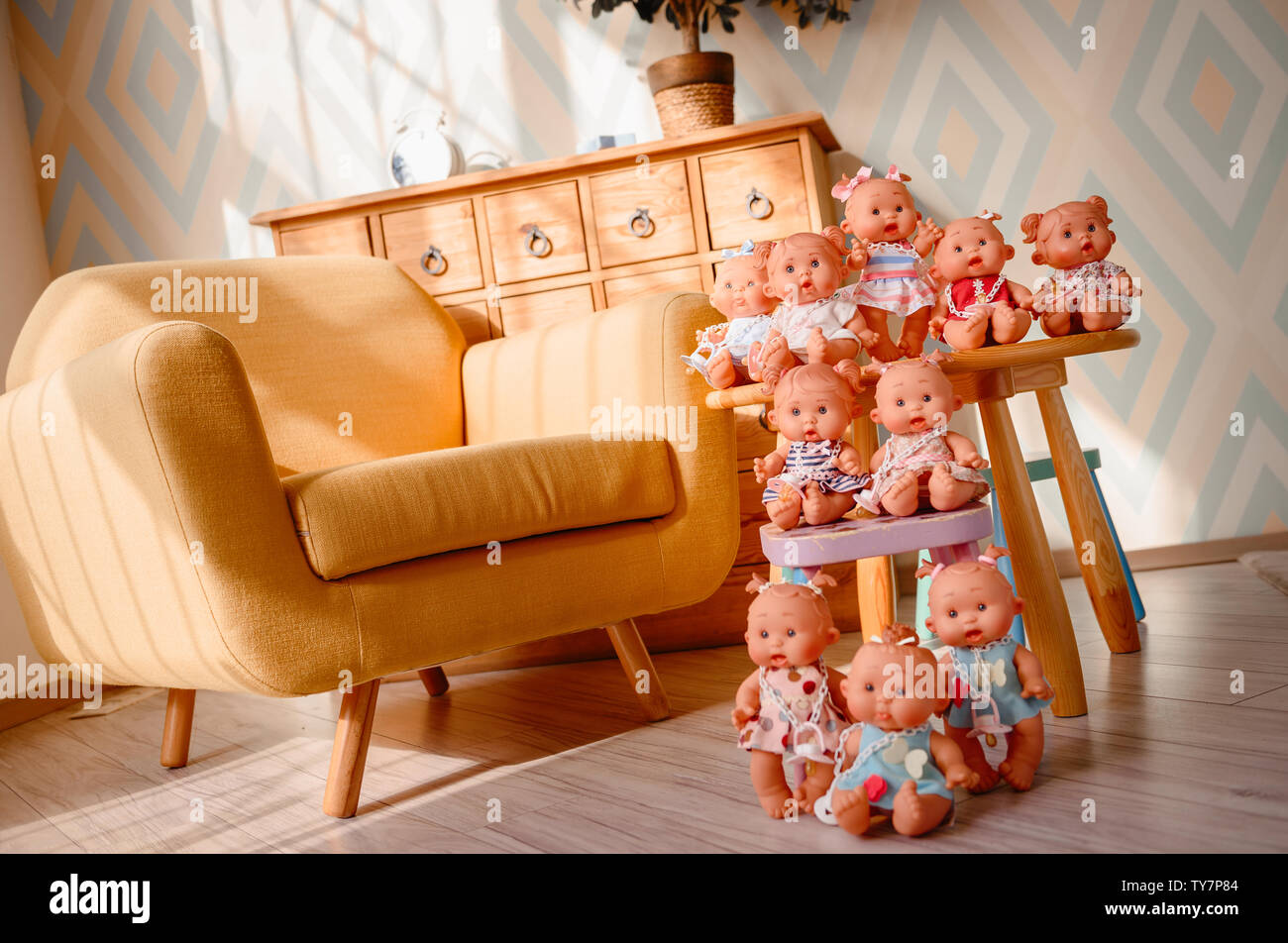 Group of cute baby dolls on the table on bright background Stock Photo ...