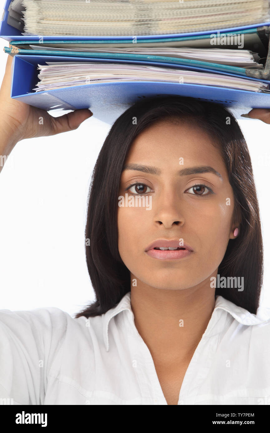 Woman balancing files on her head Stock Photo - Alamy
