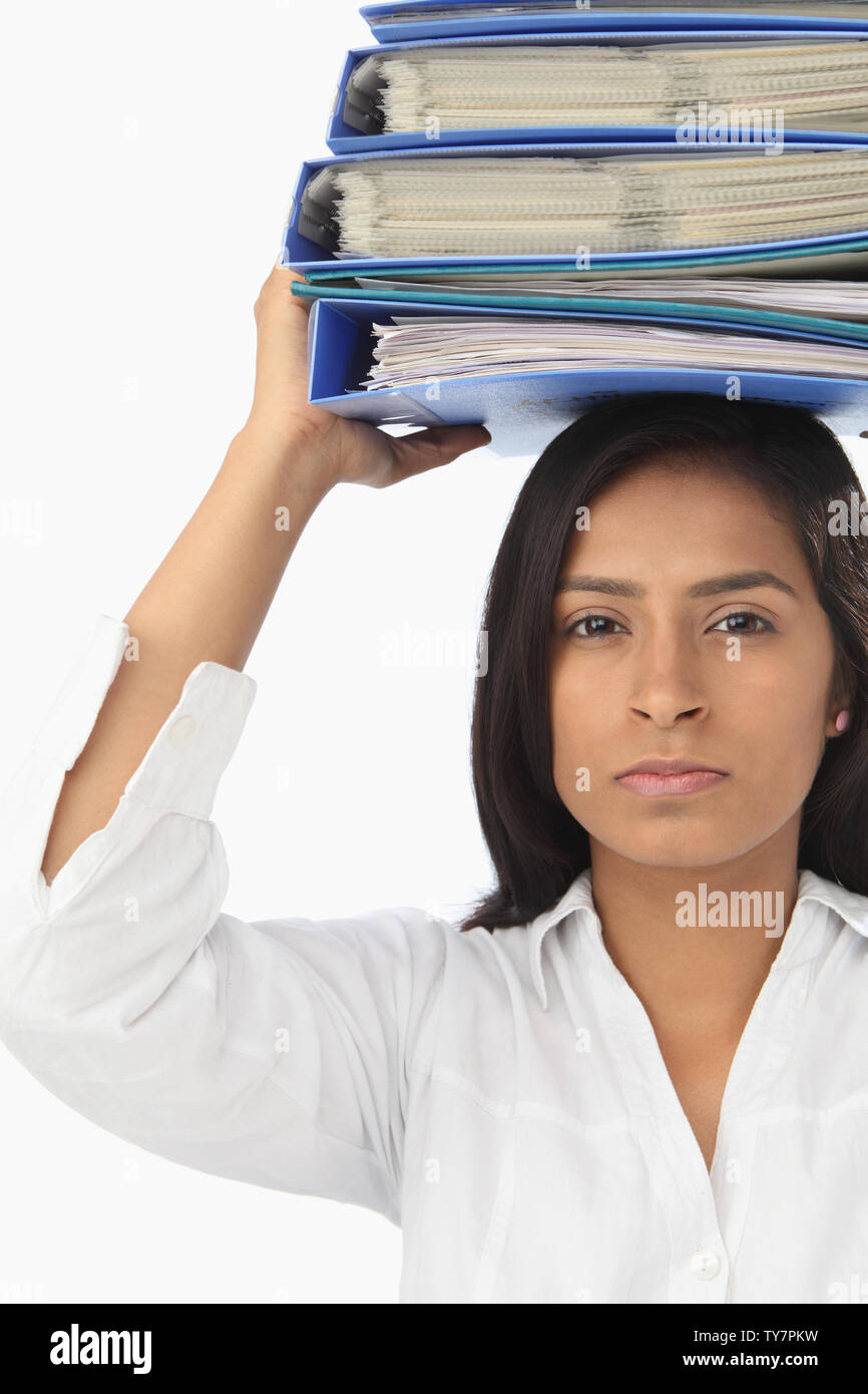 Woman balancing files on her head Stock Photo - Alamy