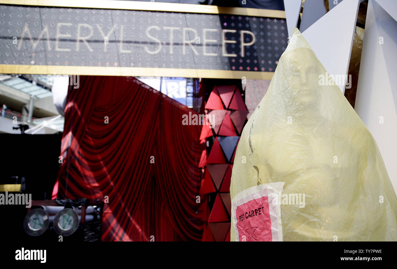 An Oscar statue is wrapped in plastic on the red carpet as preparations ...