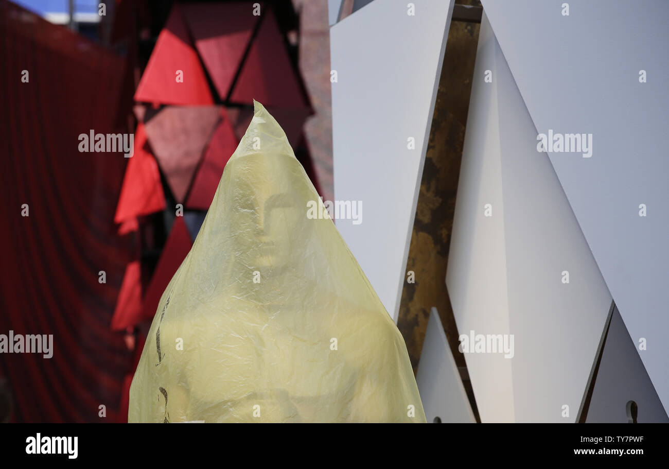 An Oscar statue is wrapped in plastic on the red carpet as preparations ...