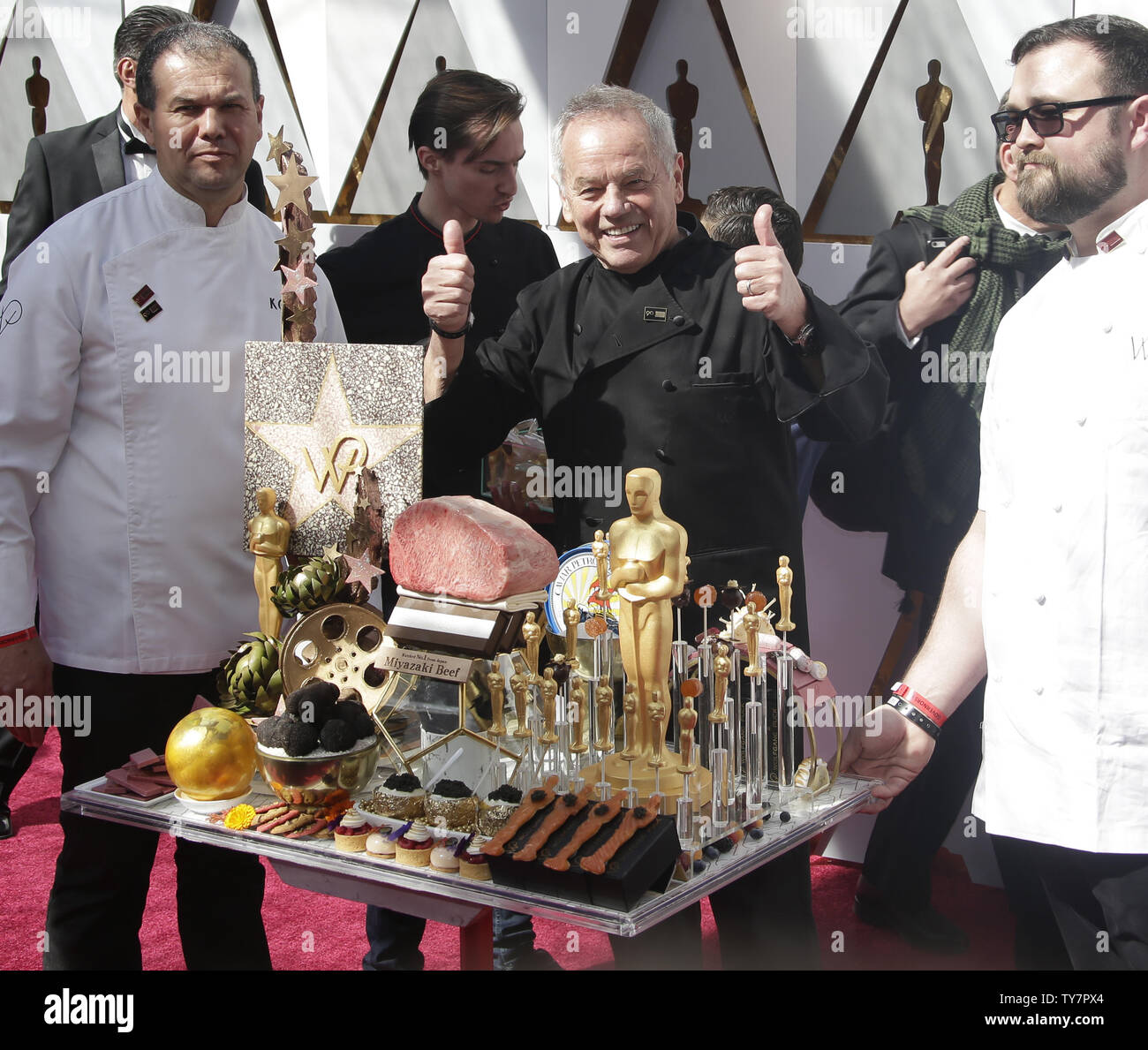 Chef Wolfgang Puck gives a thumbs up as he arrives on the red carpet ...