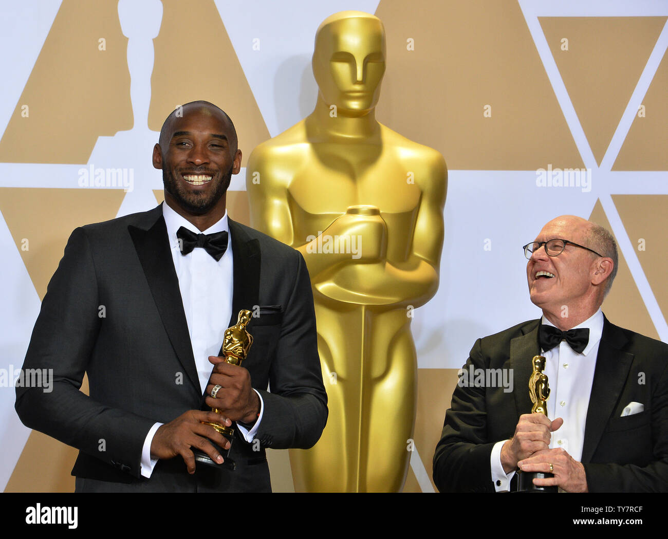 Kobe Bryant (L) and Glen Keane, winners of the Best Animated Short Film ...