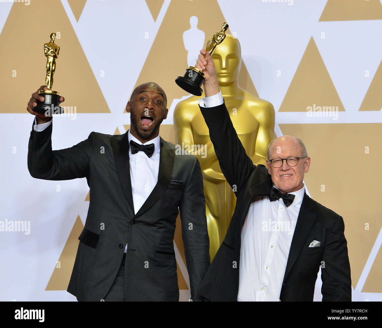 Kobe Bryant (L) and Glen Keane, winners of the Best Animated Short Film ...
