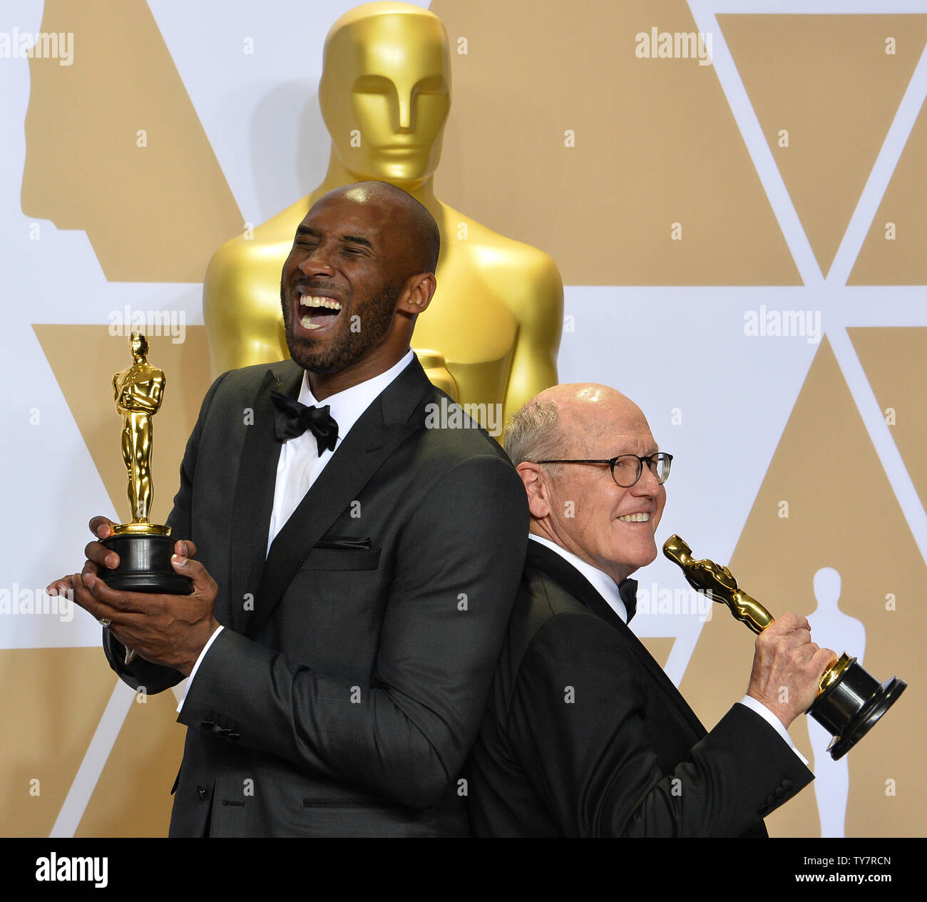 Kobe Bryant (L) and Glen Keane, winners of the Best Animated Short Film ...