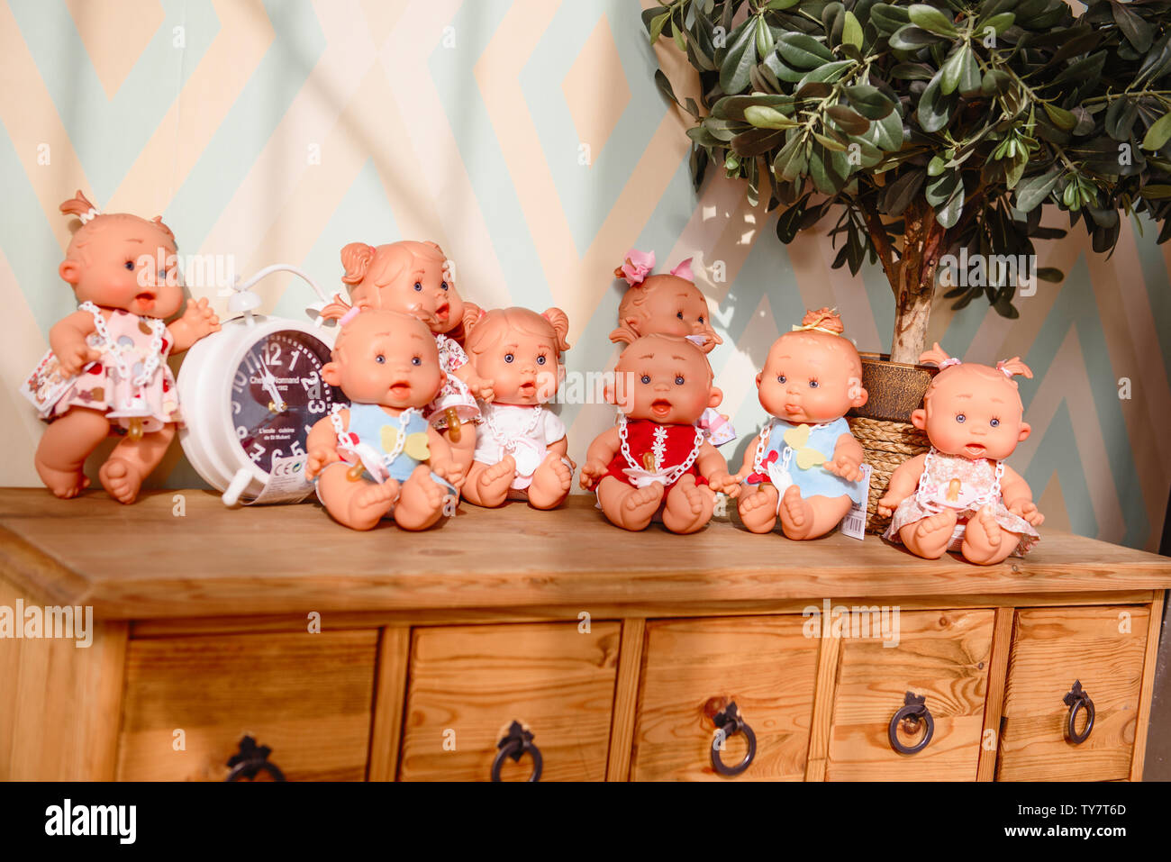 Group of cute baby dolls on the table on bright background Stock Photo ...