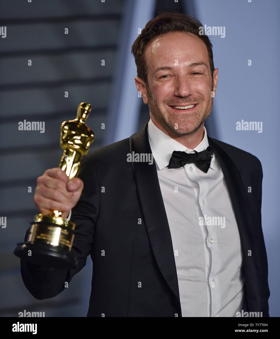 Bryan Fogel holds his Oscar for Best Documentary Feature as he arrives ...