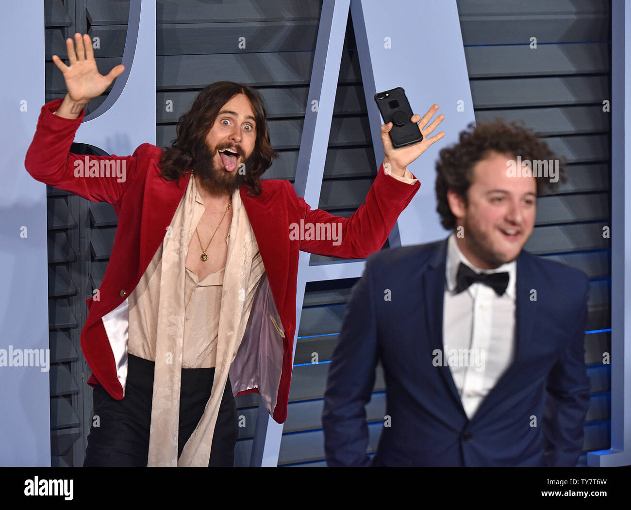 Jared Leto (L) photobombs Jason Clarke as they arrive for the Vanity ...