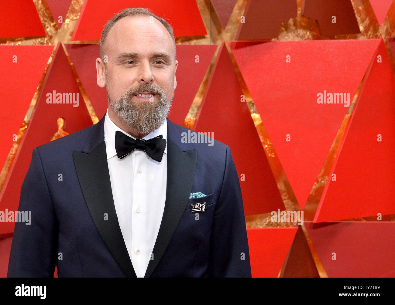 Costume designer Luis Sequeira arrives on the red carpet for the 90th ...