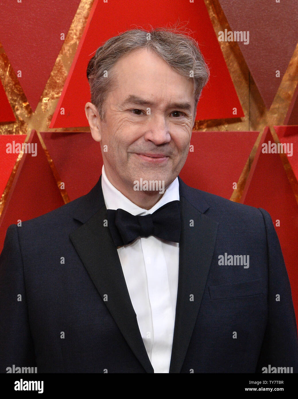 Composer Carter Burwell arrives on the red carpet for the 90th annual ...