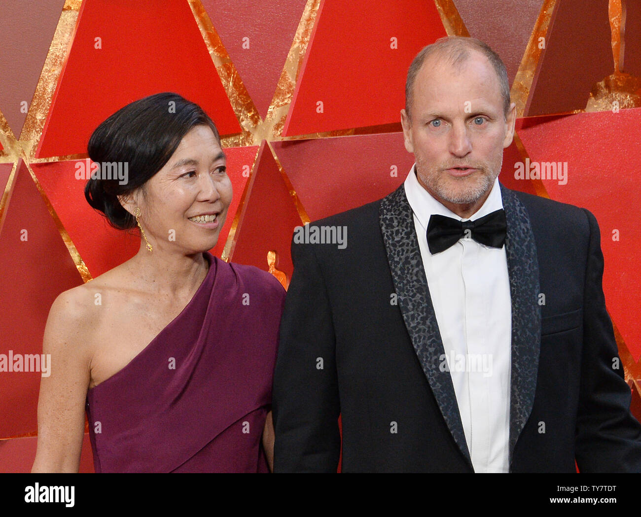 Laura Louie and actor Woody Harrelson (R) arrive on the red carpet for ...