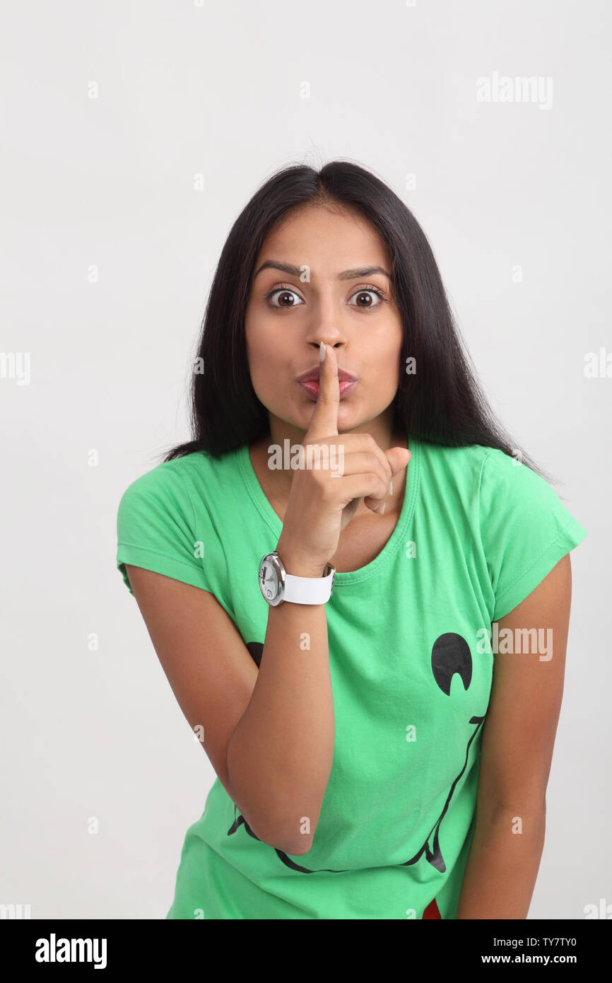 Portrait of an Indian woman with a finger on lips Stock Photo - Alamy
