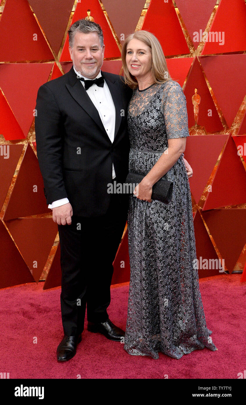 Guy Williams (L) and guest arrive on the red carpet for the 90th annual ...