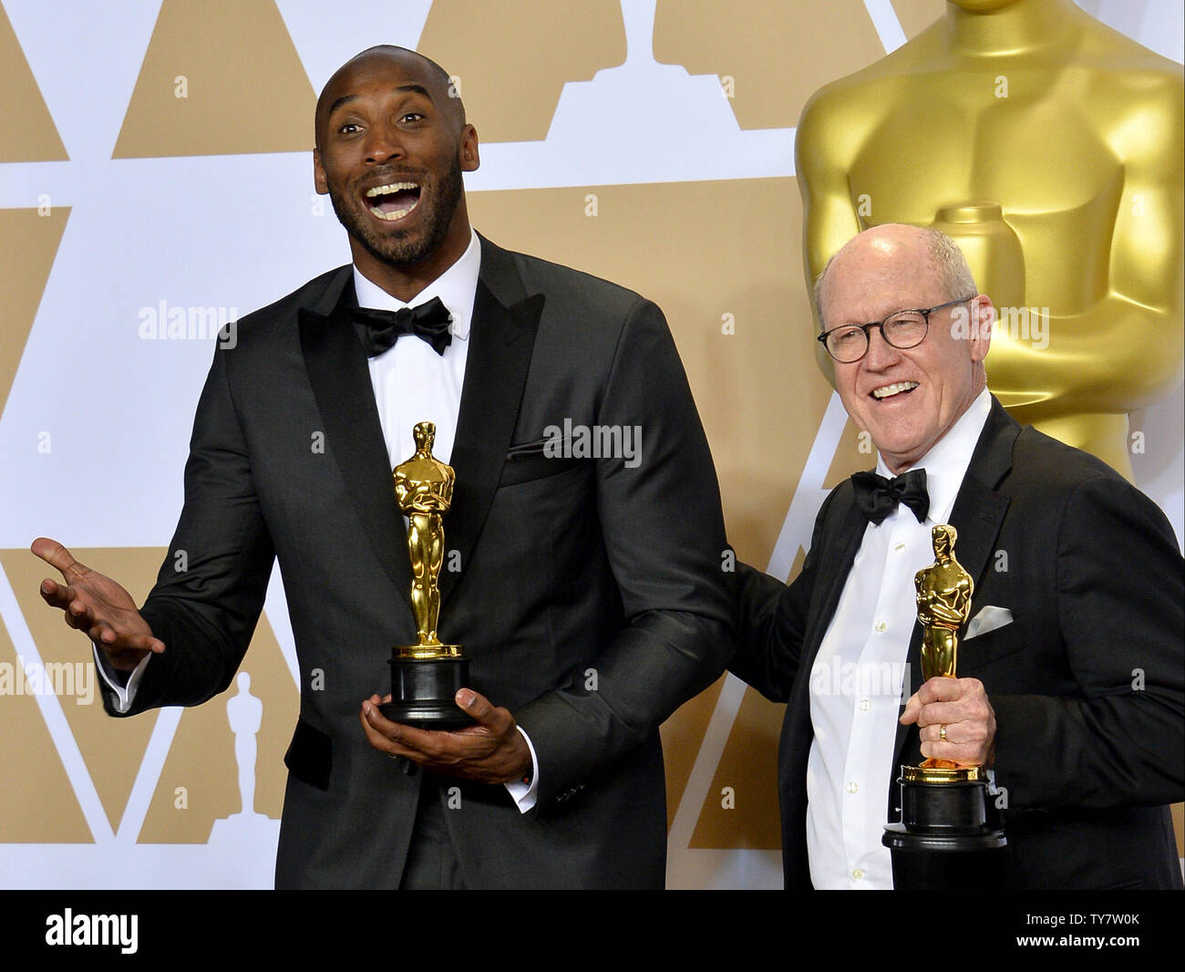 Kobe Bryant (L) and Glen Keane, winners of the Best Animated Short Film ...