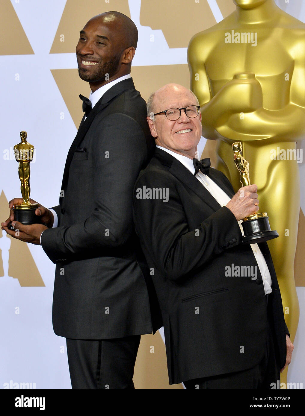 Kobe Bryant (L) and Glen Keane, winners of the Best Animated Short Film ...