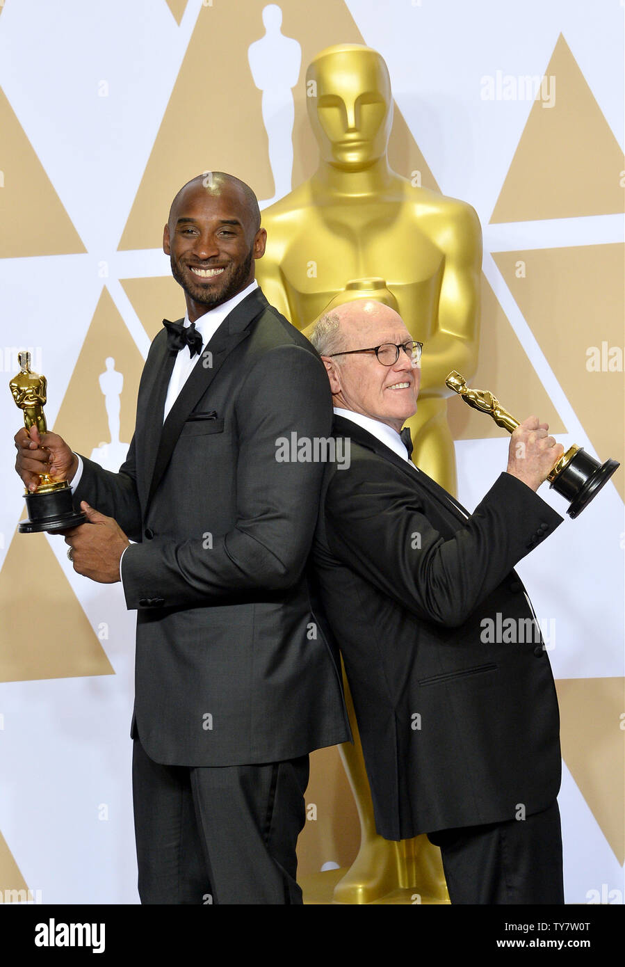 Kobe Bryant (L) and Glen Keane, winners of the Best Animated Short Film ...