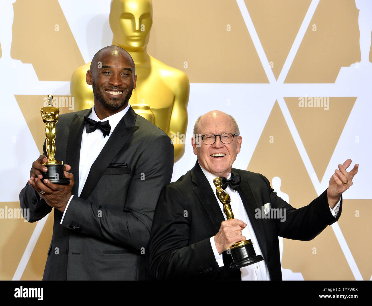 Kobe Bryant (L) and Glen Keane, winners of the Best Animated Short Film ...