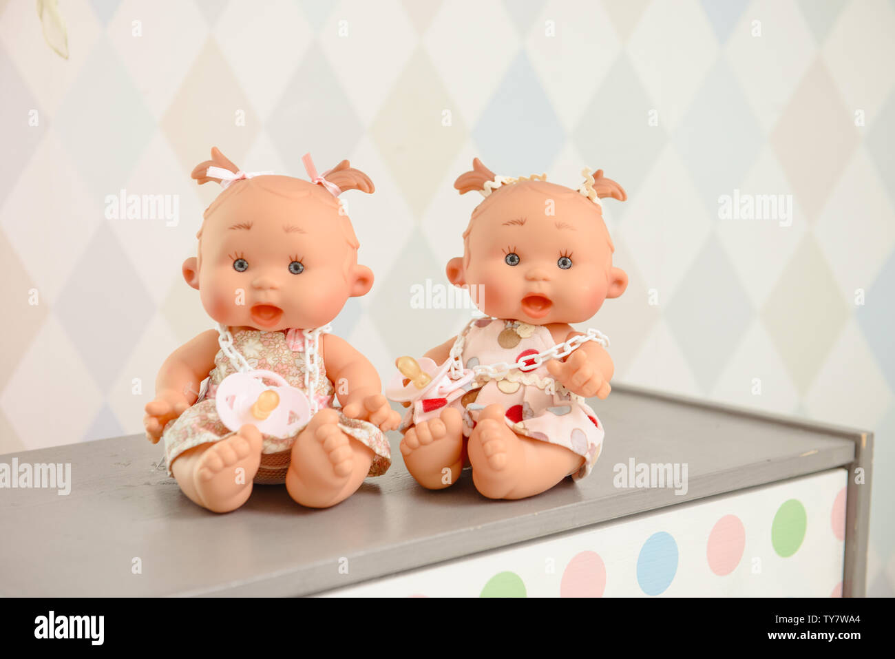 Group of cute baby dolls on the table on bright background Stock Photo ...