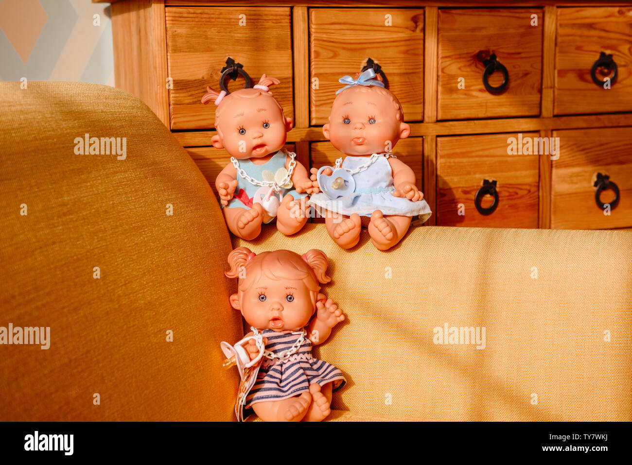 Group of cute baby dolls on the table on bright background Stock Photo ...