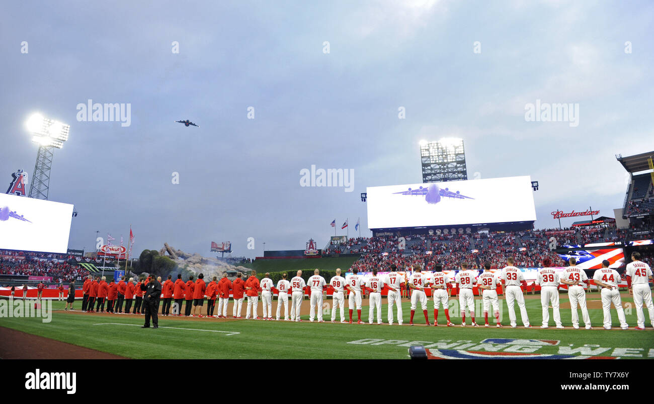 The Los Angeles Angels stand for the National Anthem during opening day ...