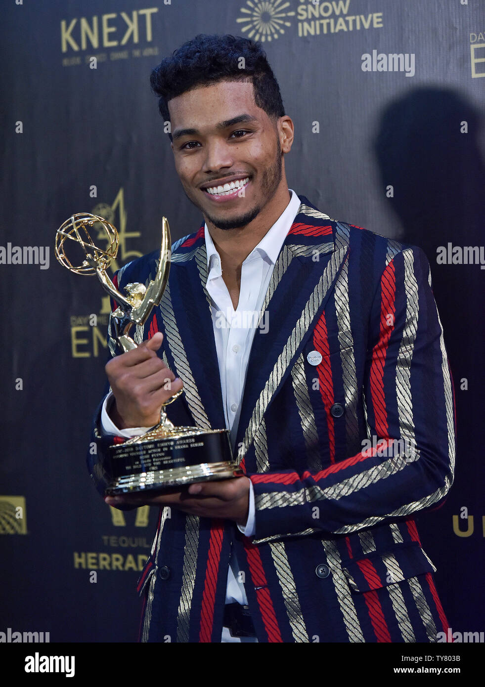 Rome Flynn holds up his award for Outstanding Younger Actor in a Drama ...