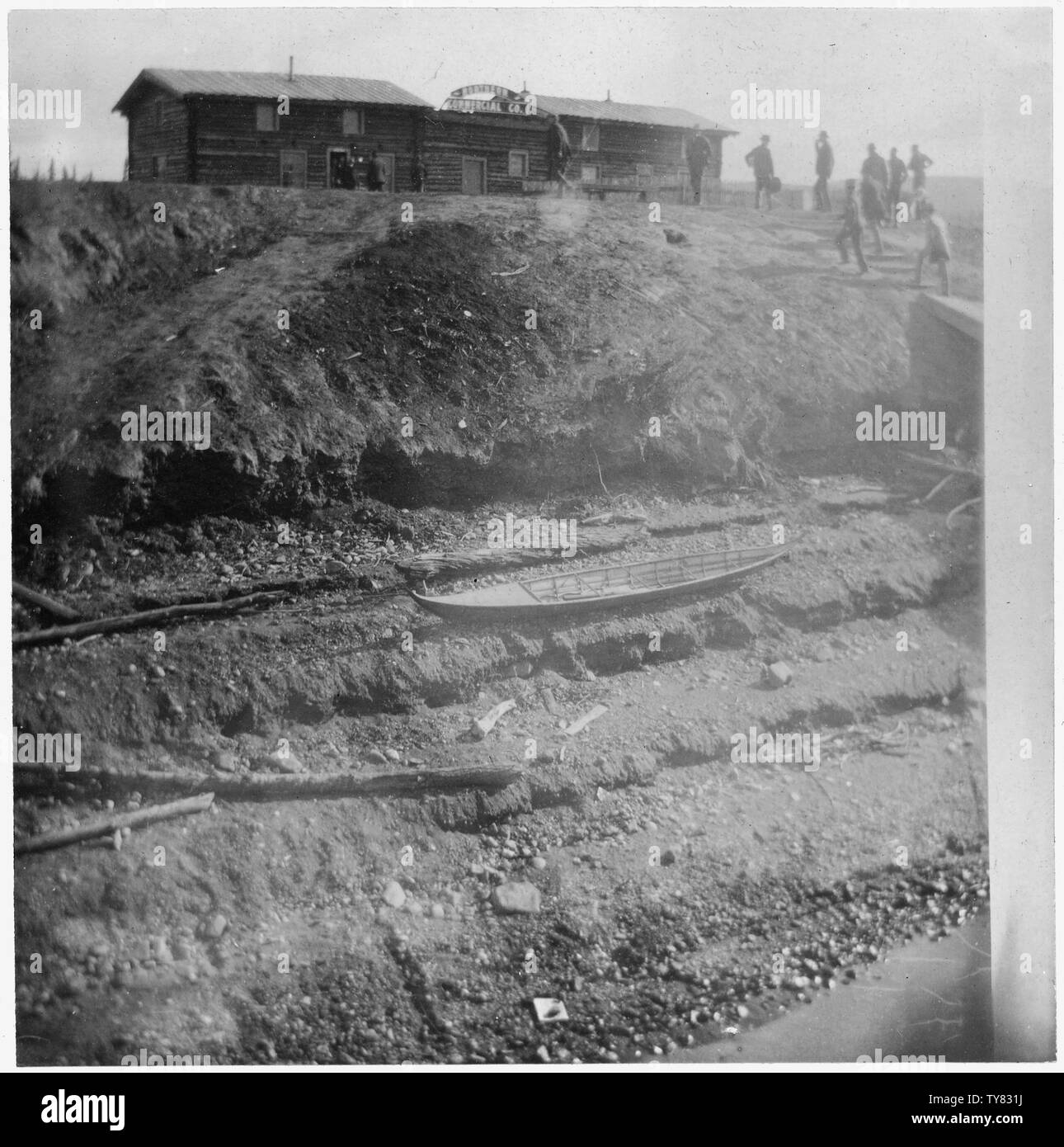 Log building with sign Northern Commercial Company. Group of men ...