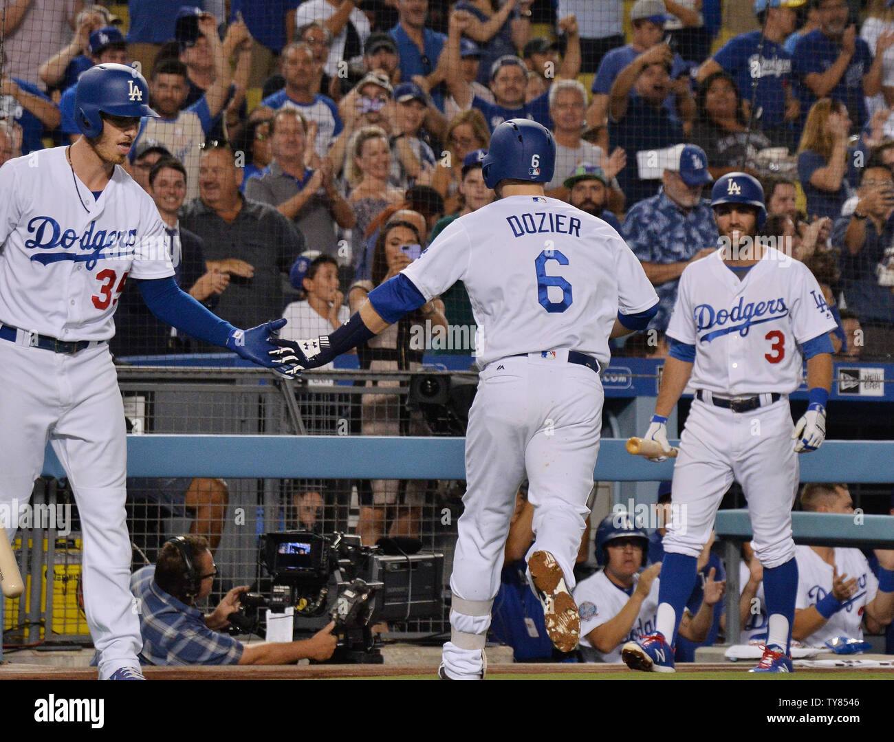 Los Angeles Dodgers' Brian Dozier celebrates with teammates Cory ...