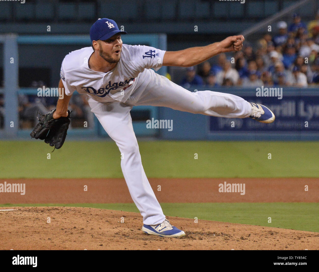 Los Angeles Dodgers' starting pitcher Rich Hill winds up to deliver in ...