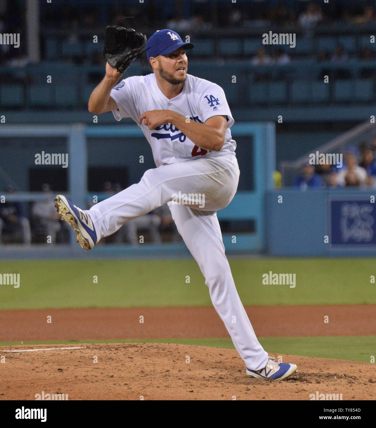 Los Angeles Dodgers' starting pitcher Rich Hill winds up to deliver in ...