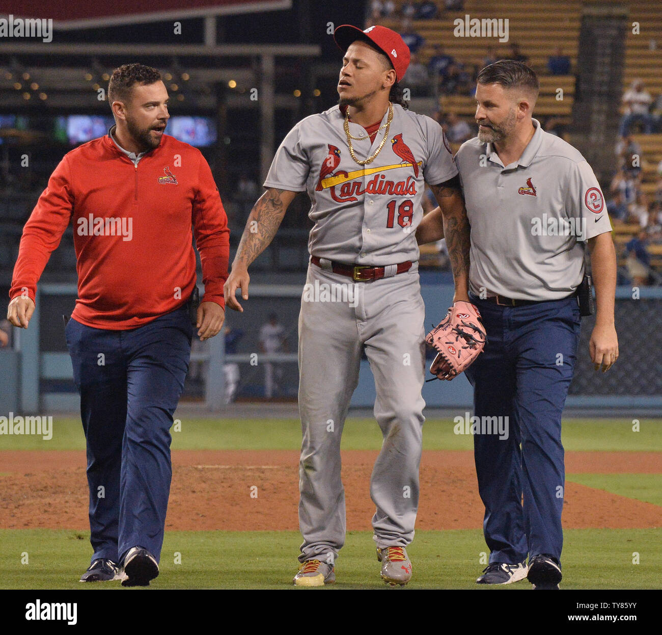 St Louis Cardinals' relief pitcher Carlos Martinez (18) is helped off ...