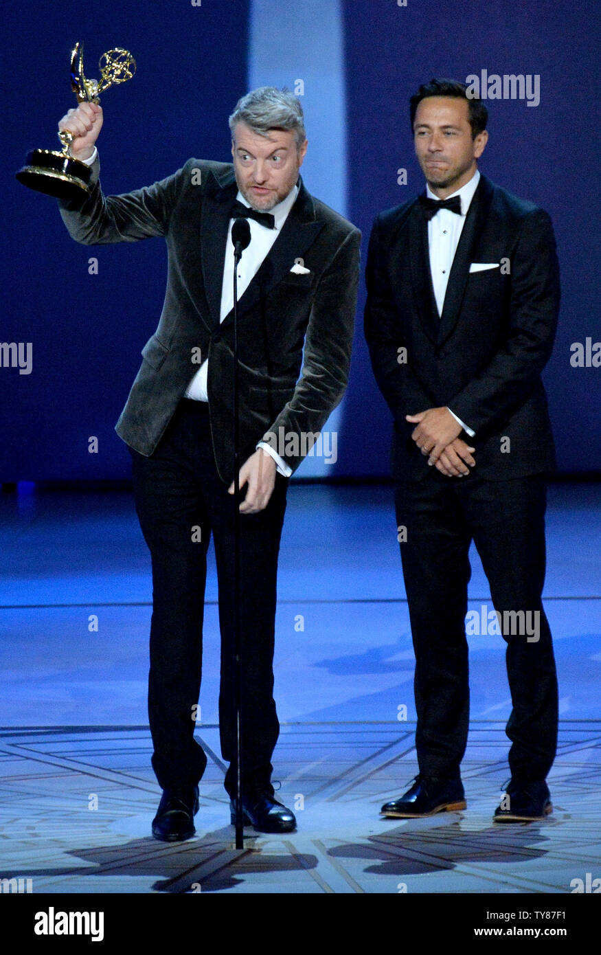 Charlie Brooker (L) and William Bridges accept the Outstanding Writing ...