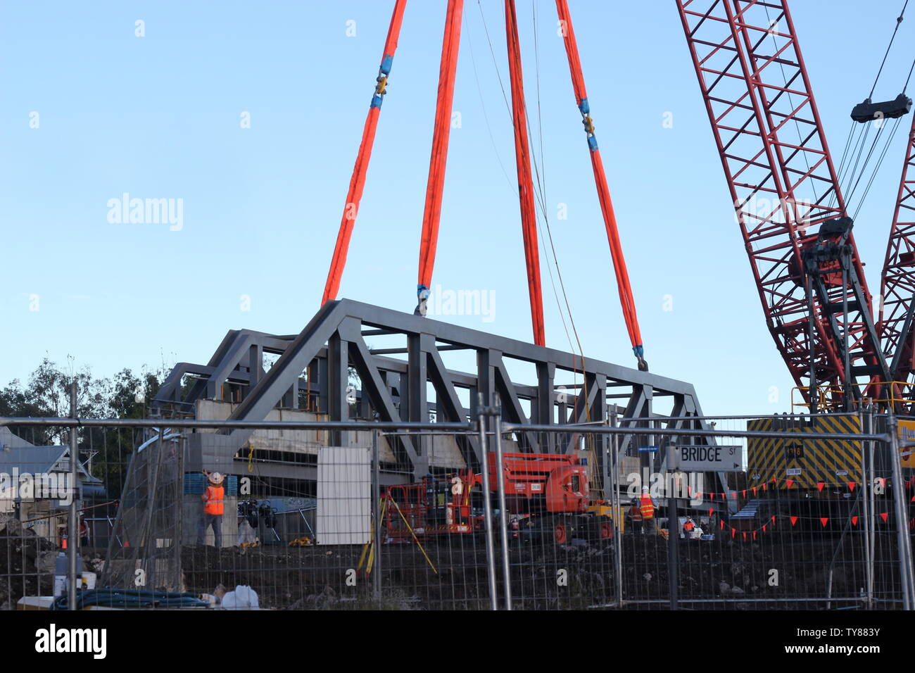 Sequence pictures of large crane lifting steel section of rail bridge ...