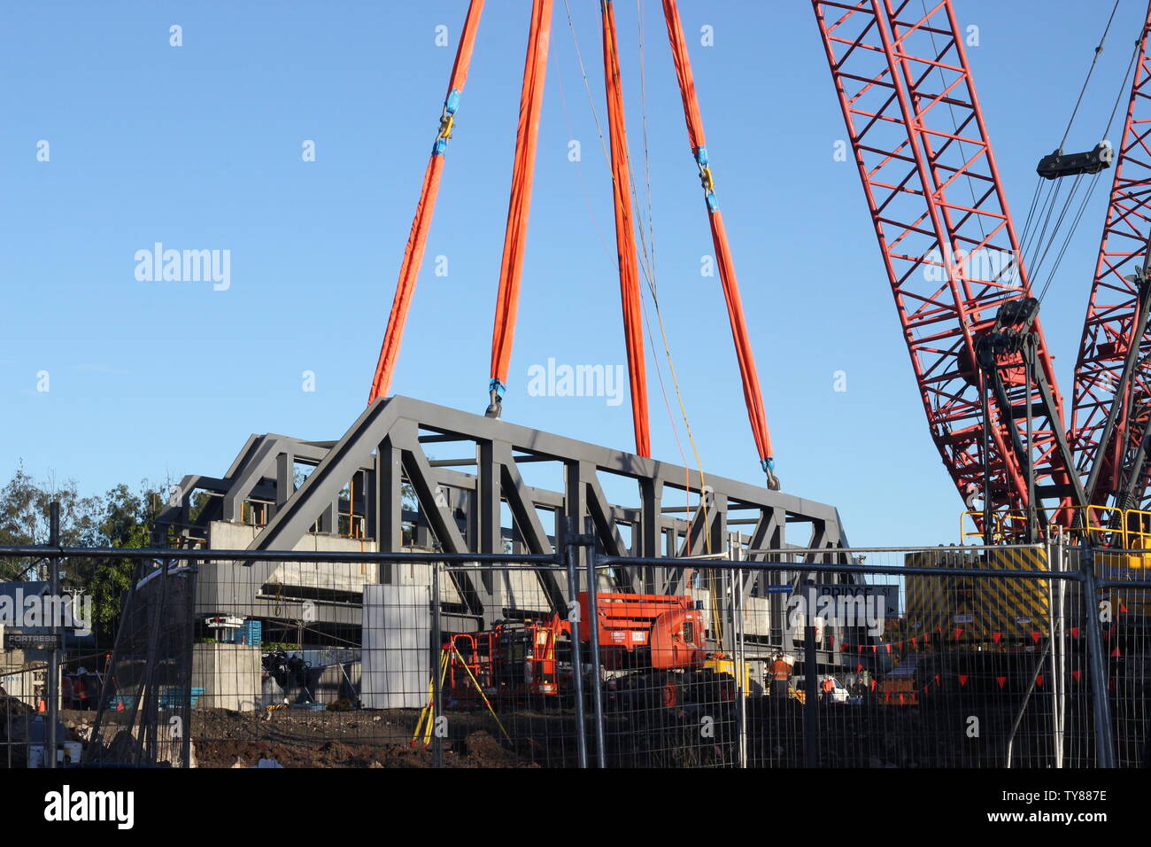 Sequence pictures of large crane lifting steel section of rail bridge ...