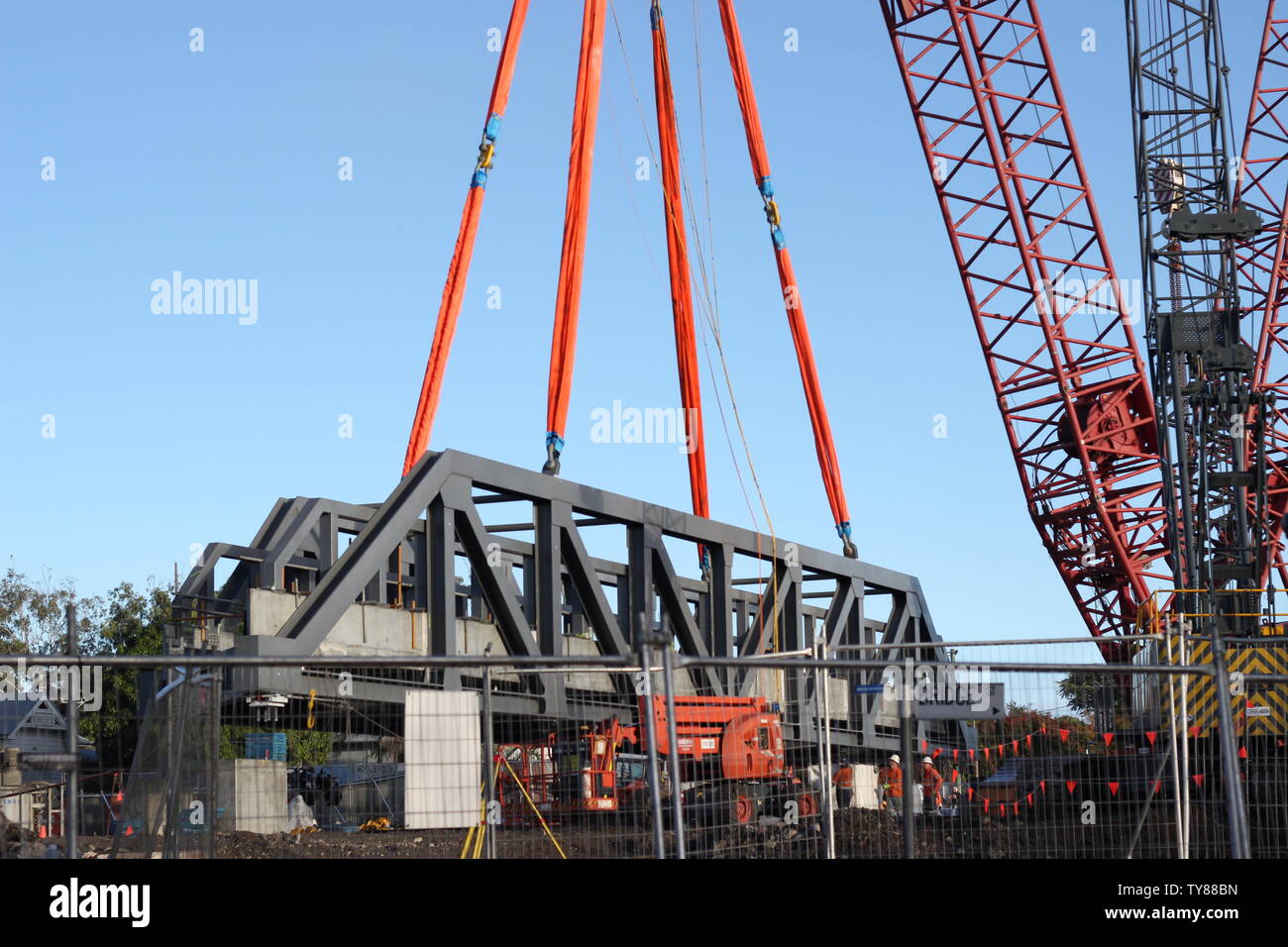 Sequence pictures of large crane lifting steel section of rail bridge ...