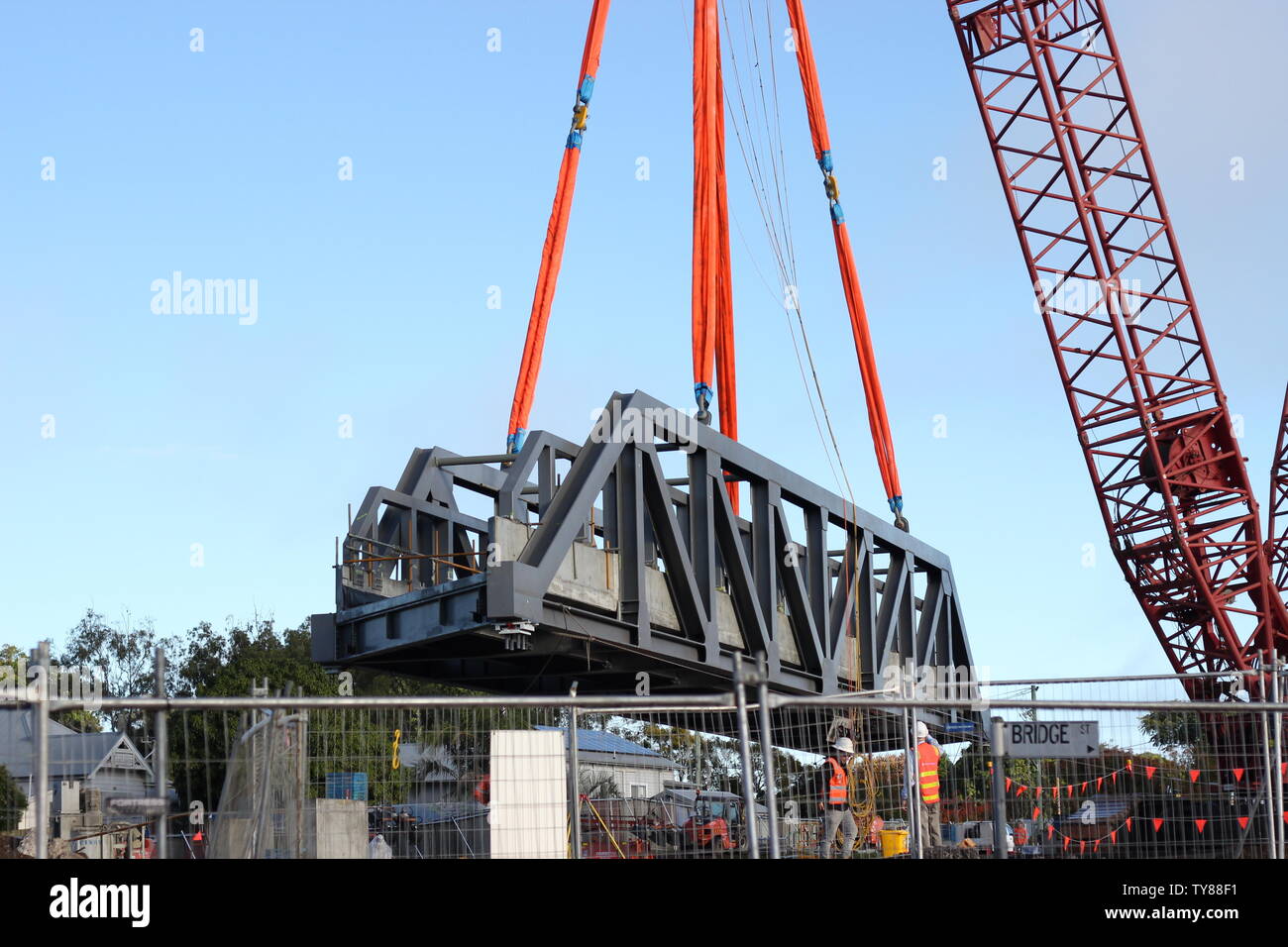 Sequence pictures of large crane lifting steel section of rail bridge ...