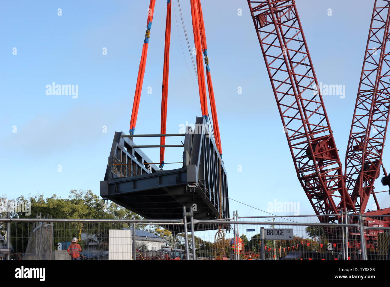Sequence pictures of large crane lifting steel section of rail bridge ...